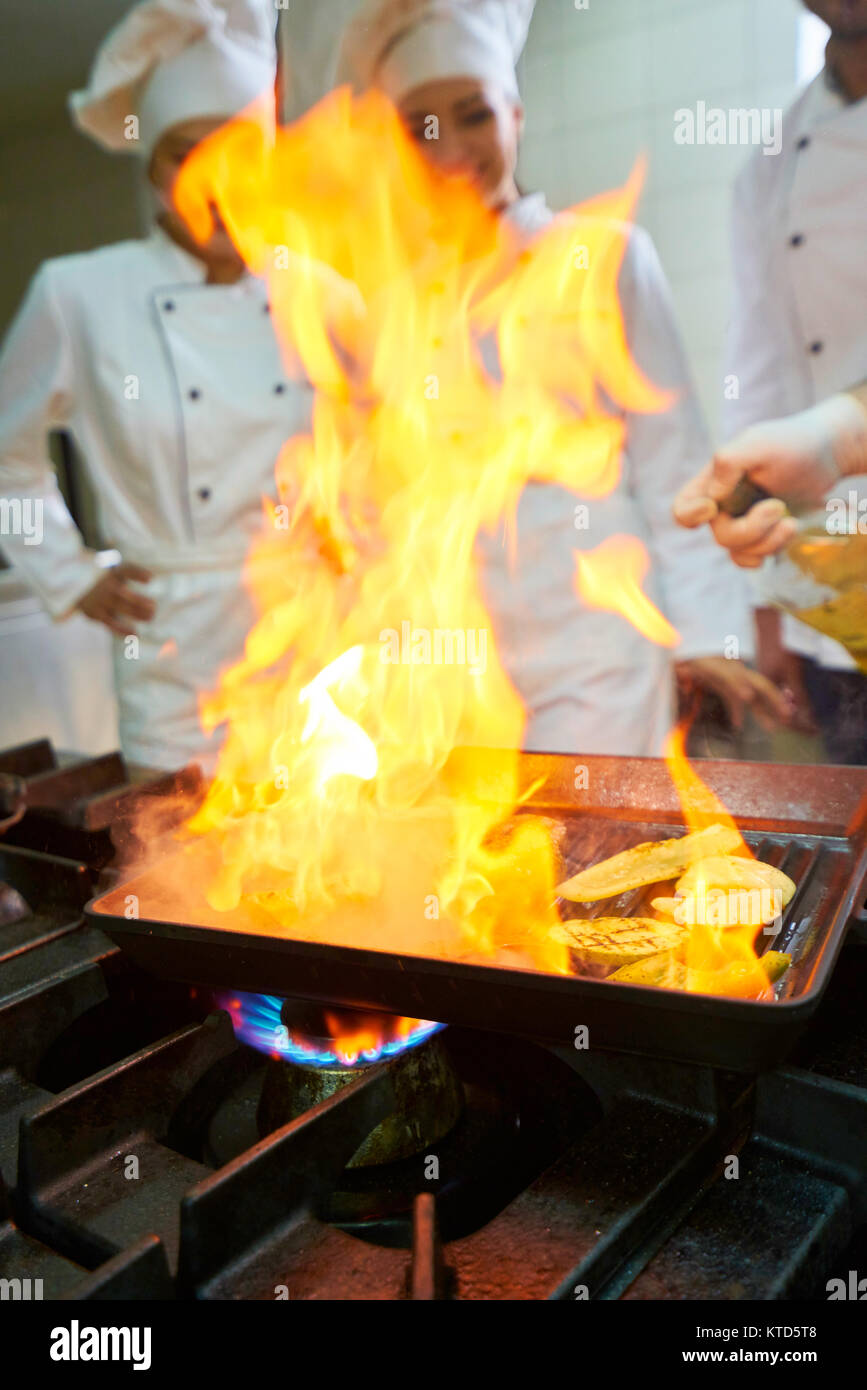 Cook working flaming pan hi-res stock photography and images - Alamy