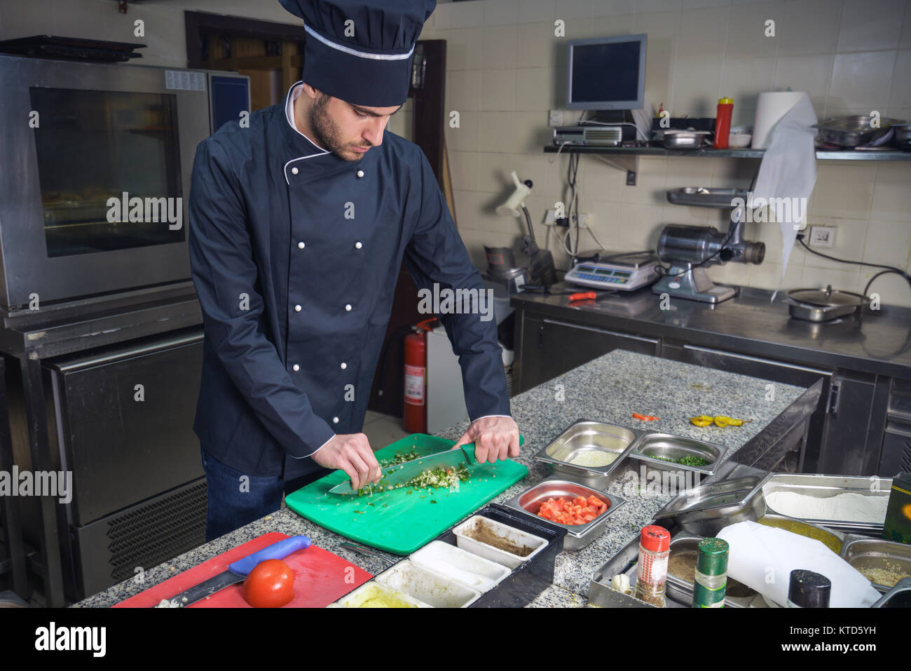 Chef in Restaurant garnishing vegetable dish, crop on hands, filtered ...