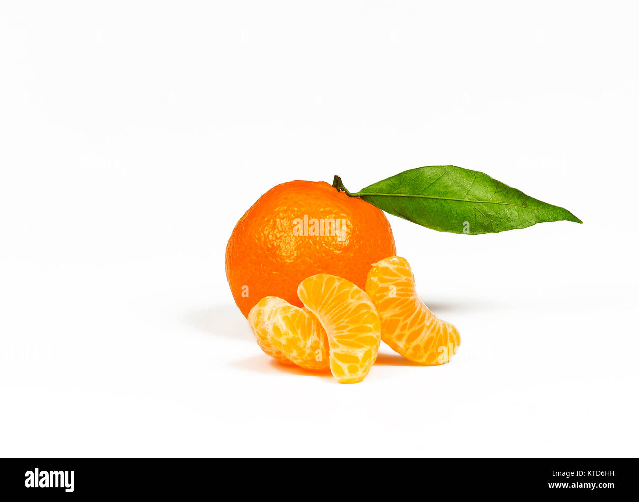 One orange mandarin and several peeled mandarin slices close-up on a ...