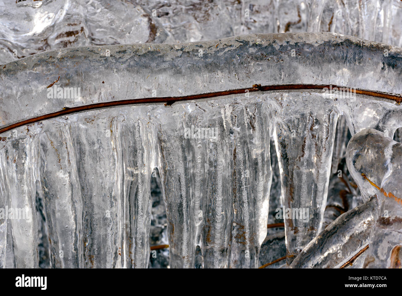 Icicle formations frozen on a stick over running water Stock Photo - Alamy