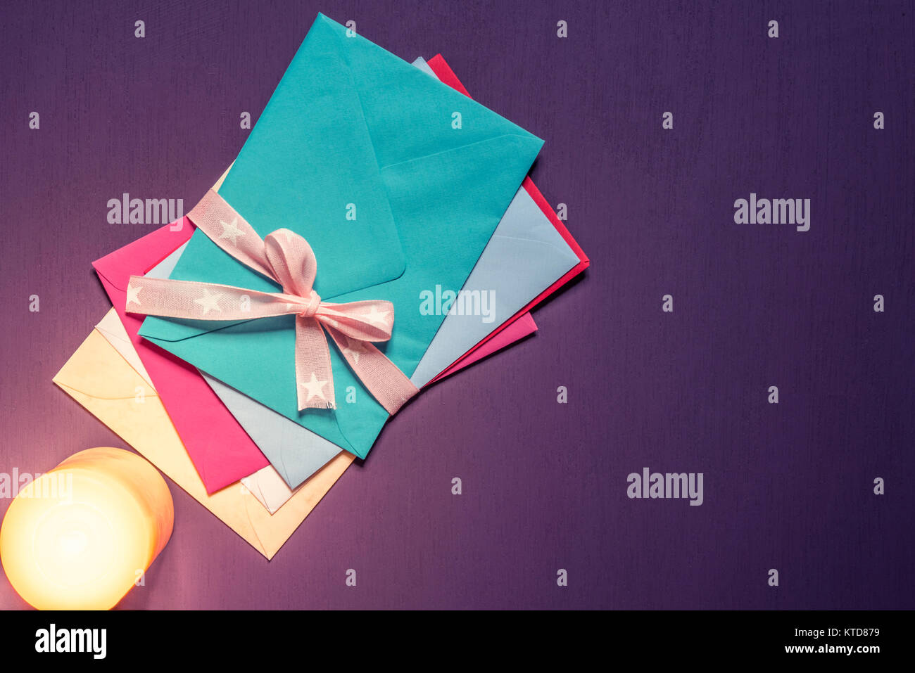 Bunch of multicolored letters tied together with a pink ribbon and bow ...