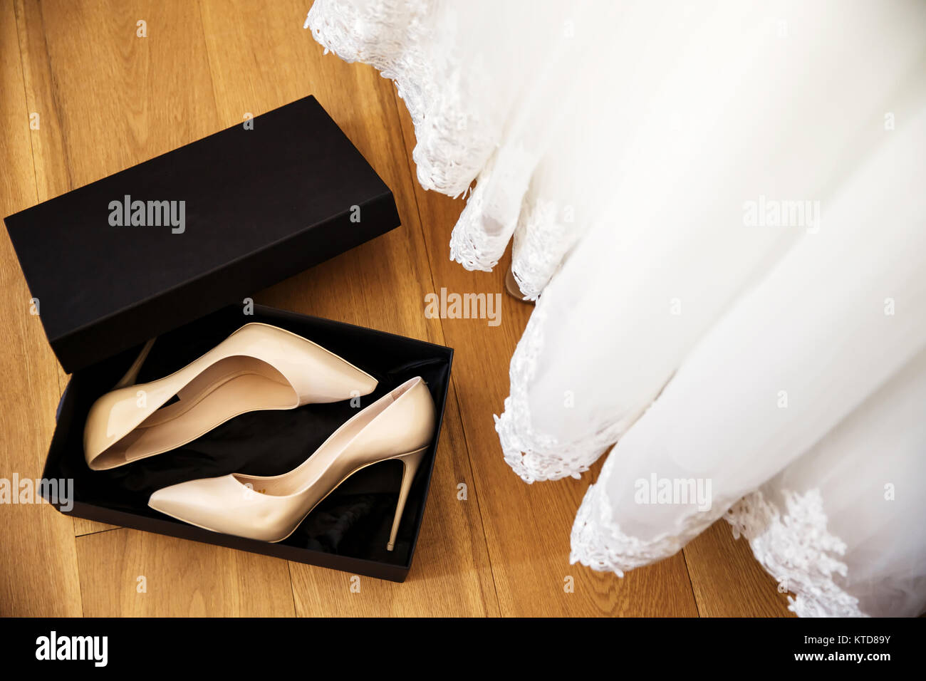 Wedding shoes in black box and part of wedding dress Stock Photo - Alamy