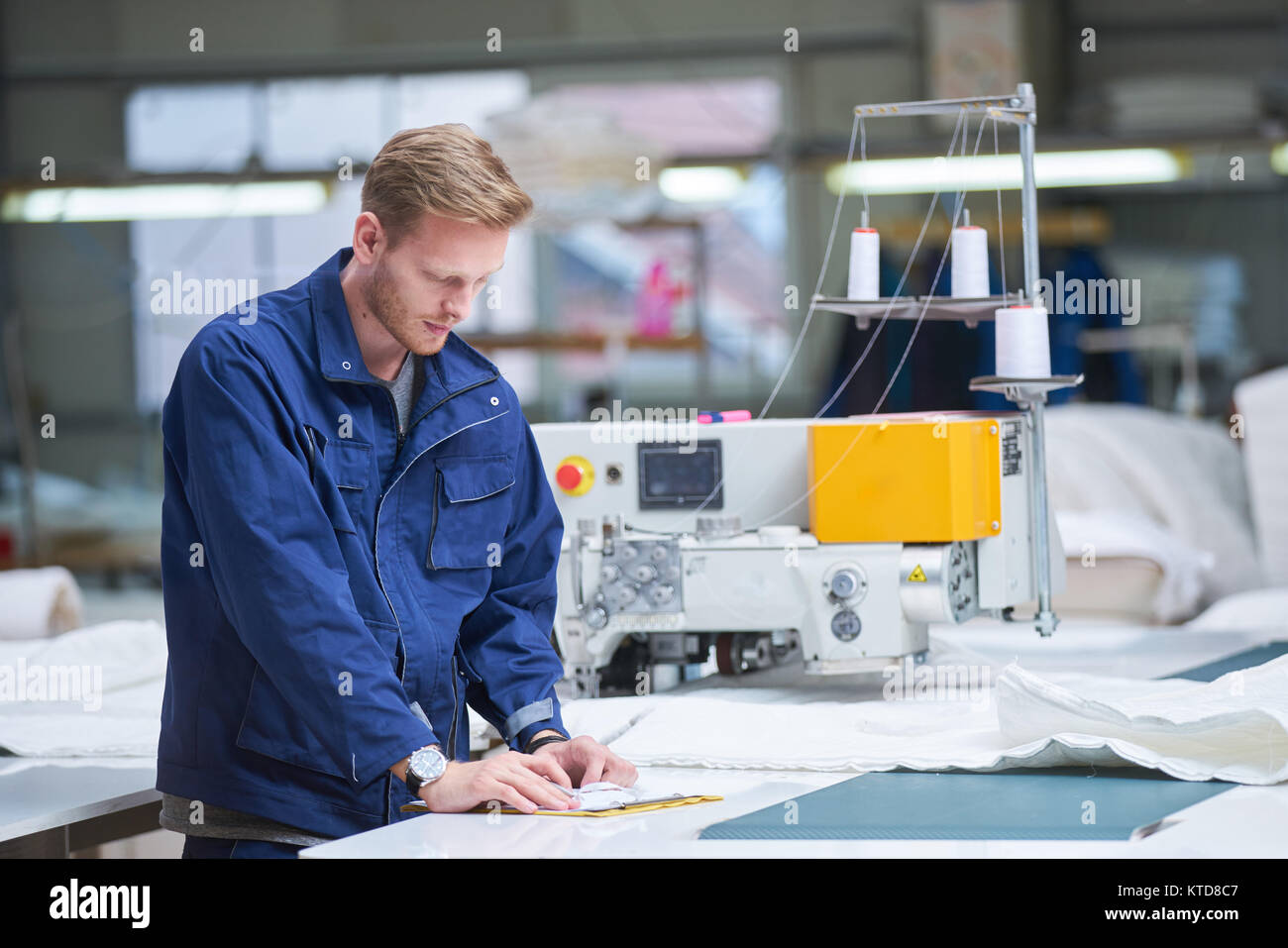 worker in protective clothing in factory using machine Stock Photo - Alamy