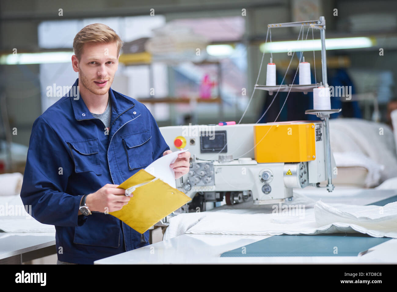 worker in protective clothing in factory using machine Stock Photo - Alamy