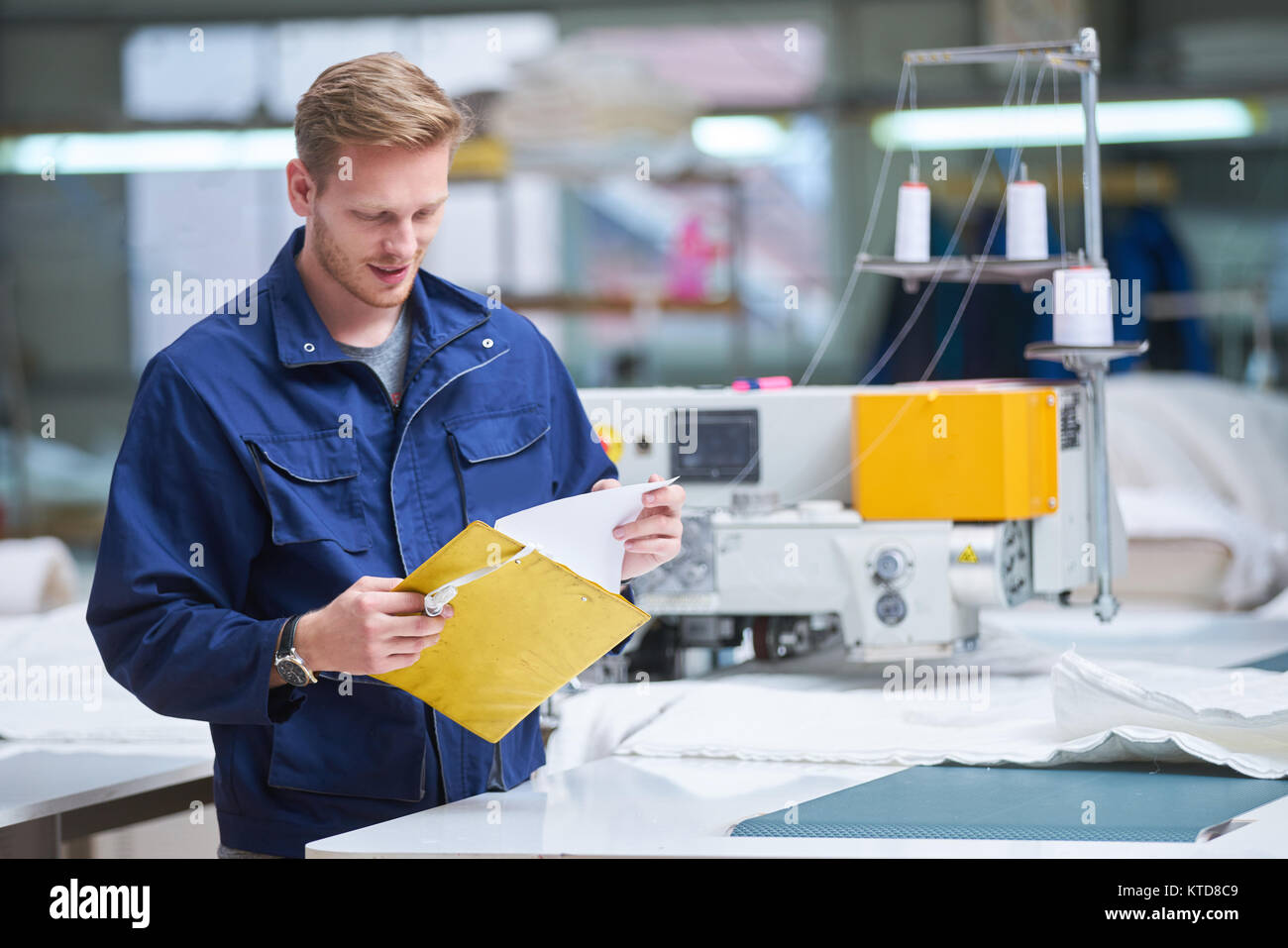 worker in protective clothing in factory using machine Stock Photo - Alamy