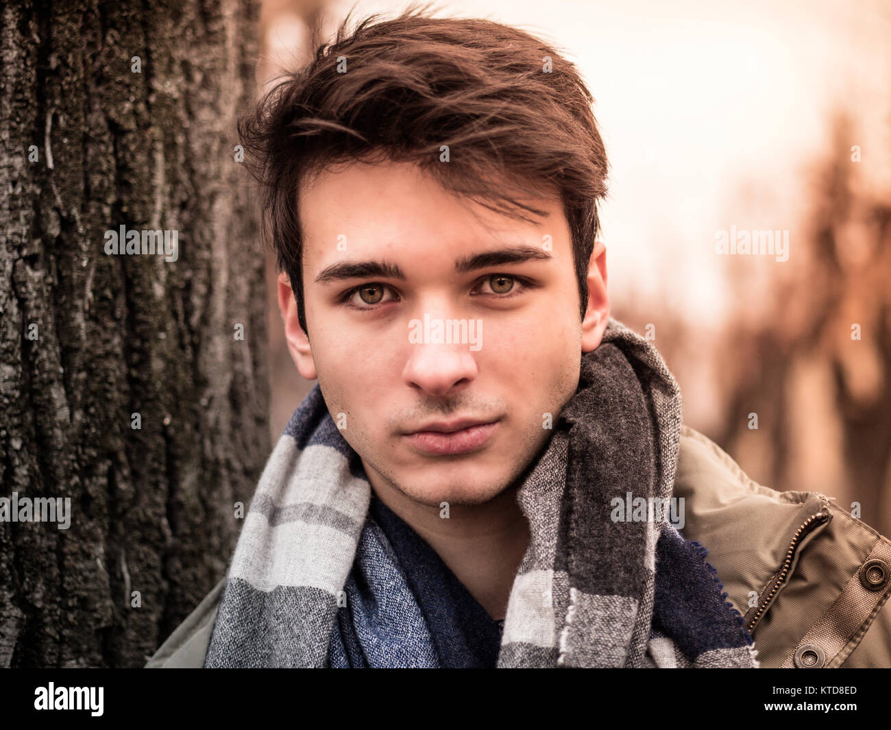 Handsome young man outdoor in winter fashion, wearing dark jacket and ...