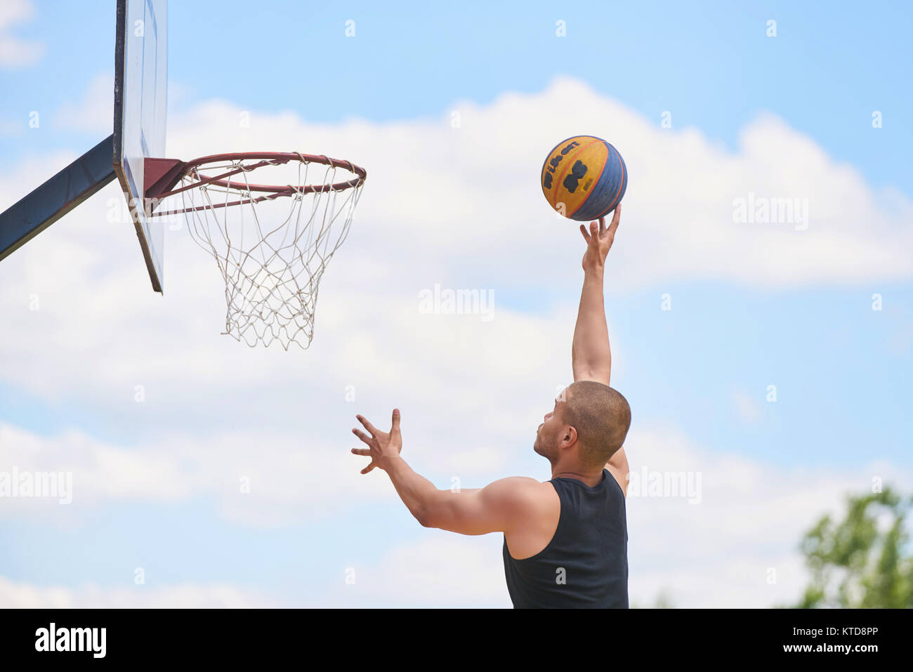 Basketball player in action flying high and scoring Stock Photo - Alamy