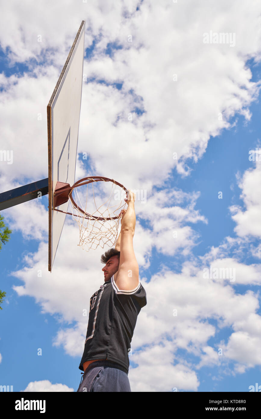 Basketball player in action flying high and scoring Stock Photo - Alamy