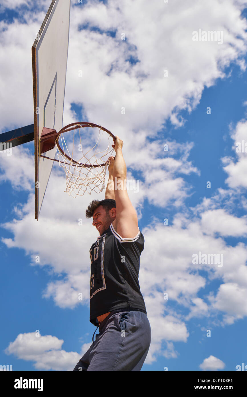 Basketball player in action flying high and scoring Stock Photo - Alamy