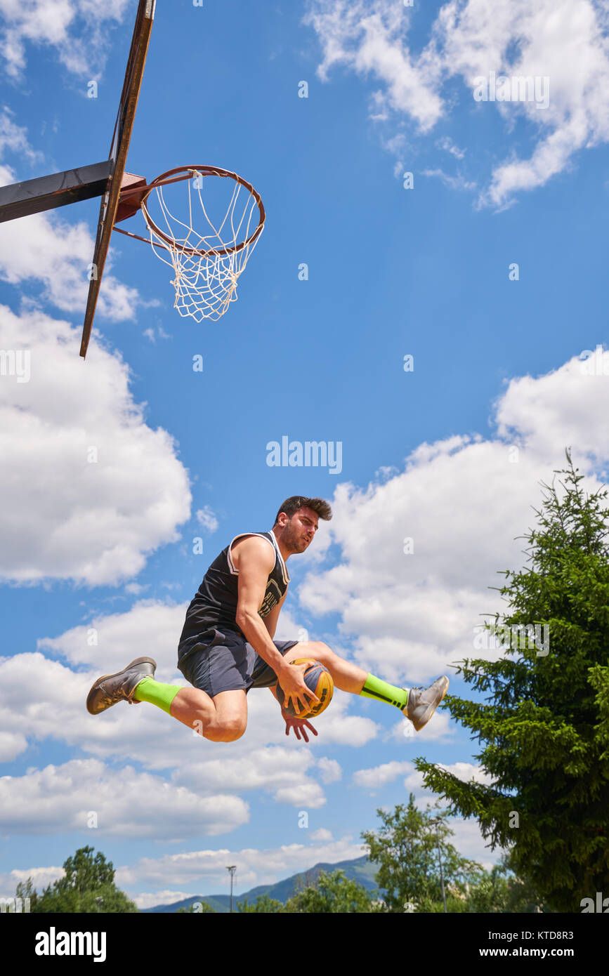 Basketball player in action flying high and scoring Stock Photo - Alamy