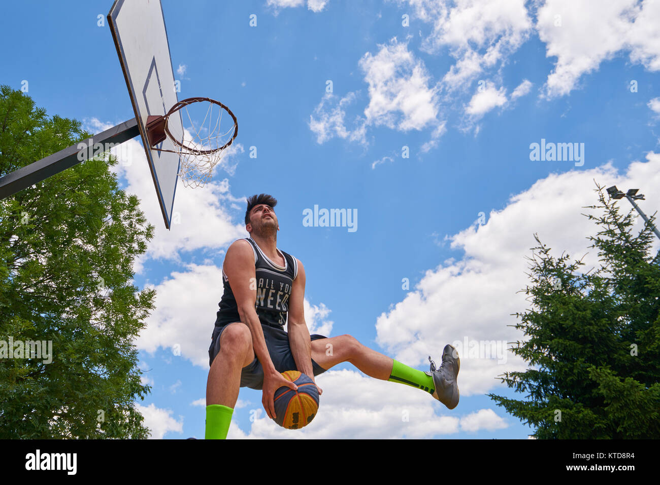 Basketball player in action flying high and scoring Stock Photo - Alamy