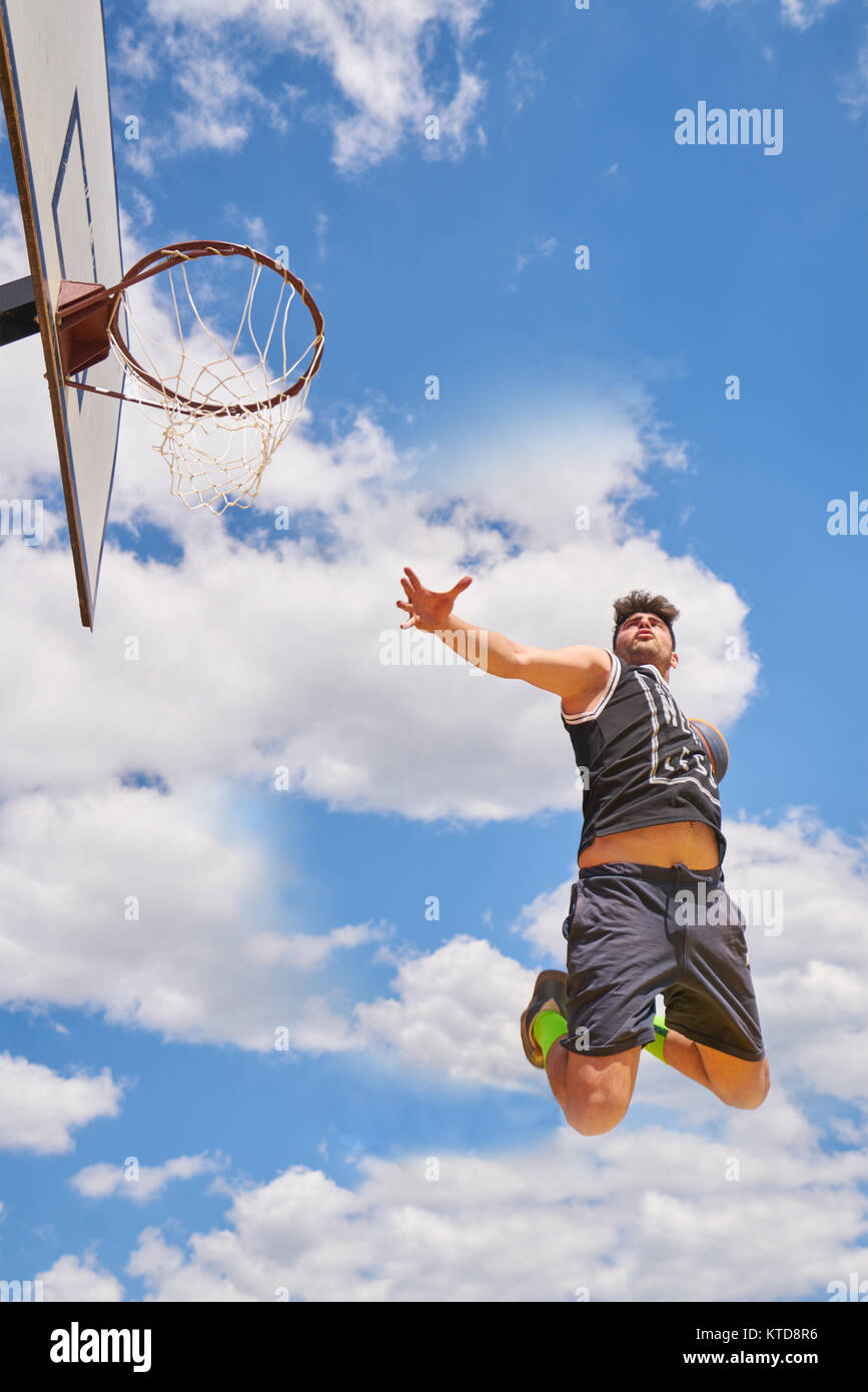 Basketball player in action flying high and scoring Stock Photo - Alamy