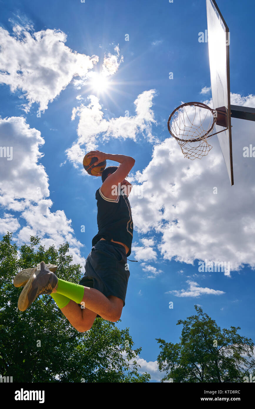 Basketball player in action flying high and scoring Stock Photo - Alamy