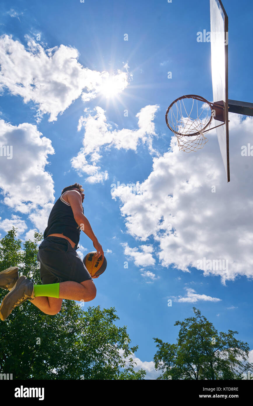 Basketball player in action flying high and scoring Stock Photo - Alamy