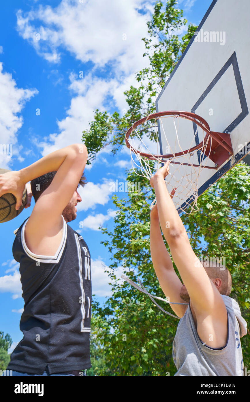 Basketball player in action flying high and scoring Stock Photo - Alamy