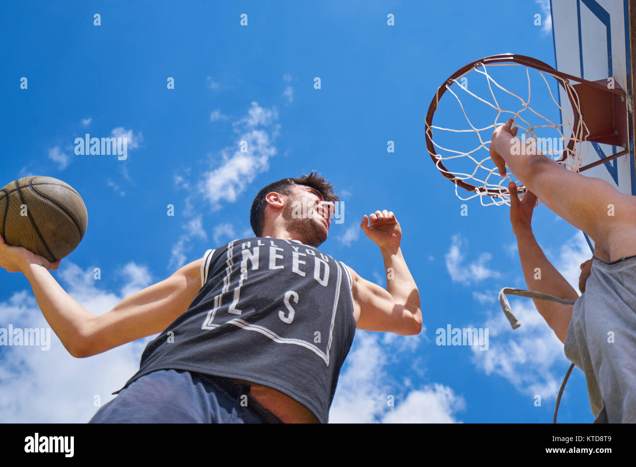 Basketball player in action flying high and scoring Stock Photo - Alamy