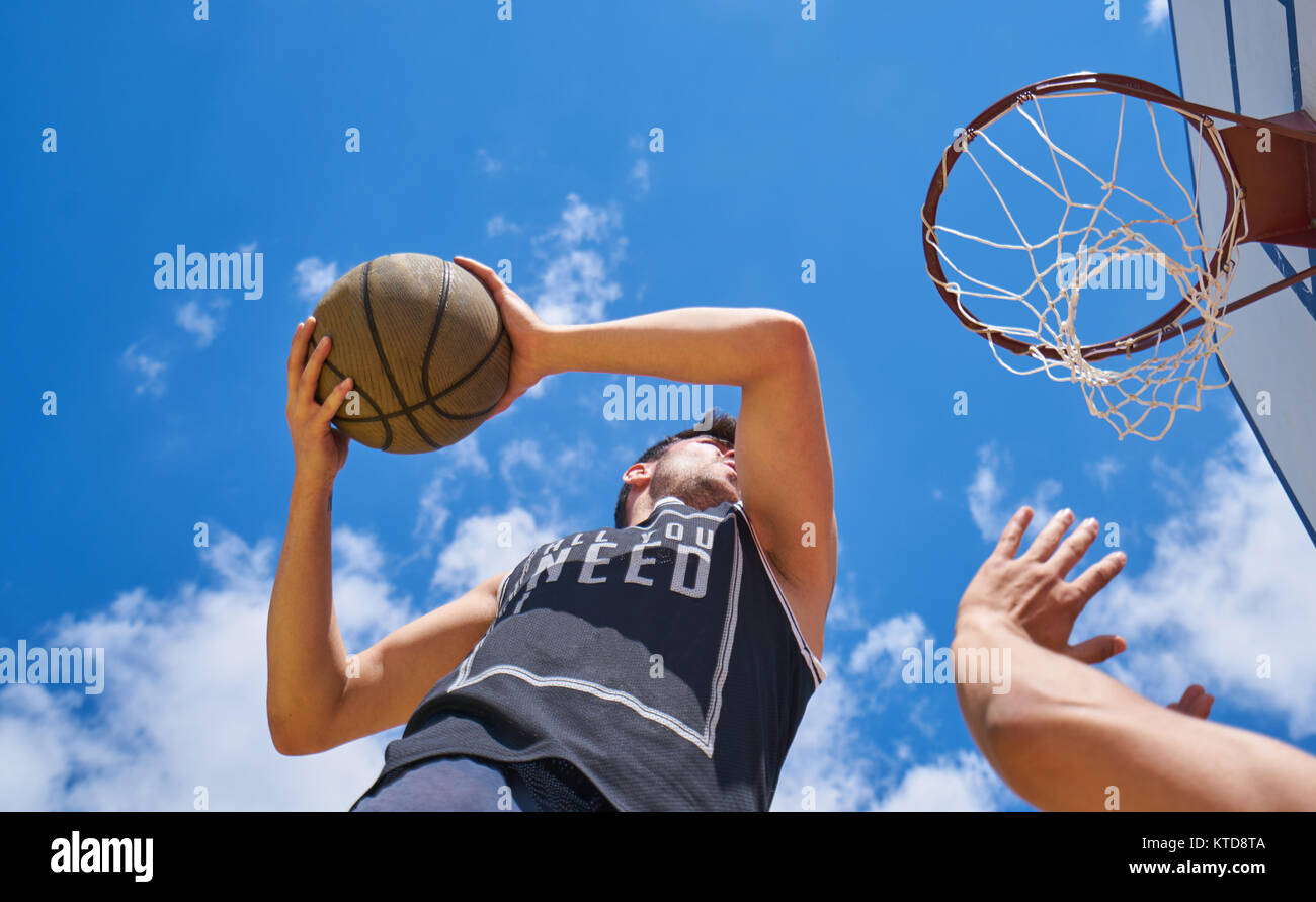 Basketball player in action flying high and scoring Stock Photo - Alamy