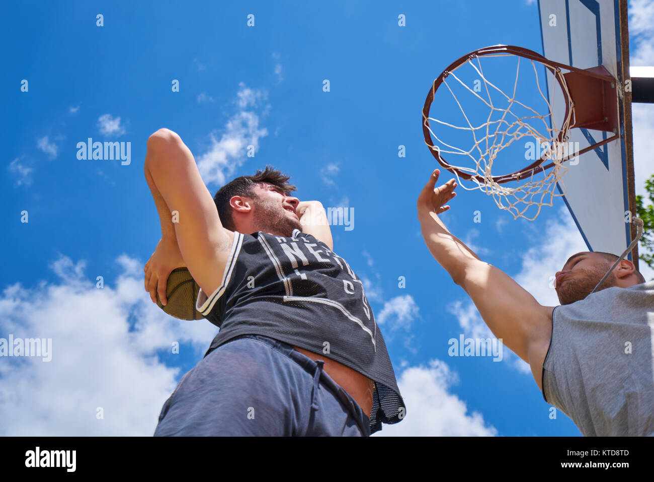 Basketball player in action flying high and scoring Stock Photo - Alamy