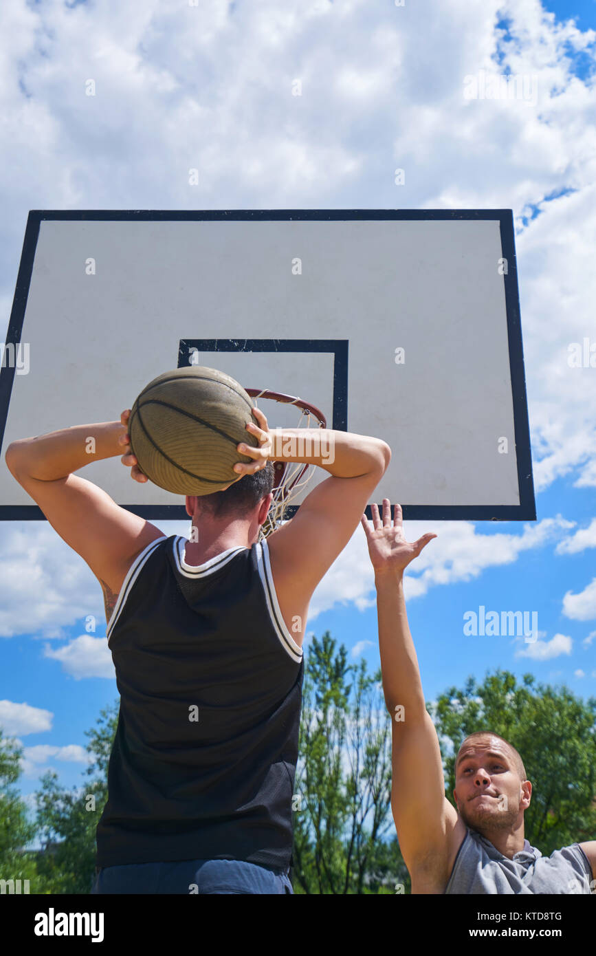 Basketball player in action flying high and scoring Stock Photo - Alamy