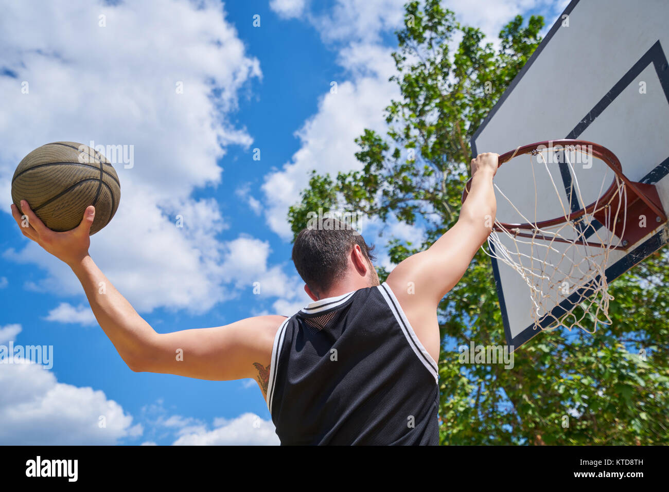 Basketball player in action flying high and scoring Stock Photo - Alamy