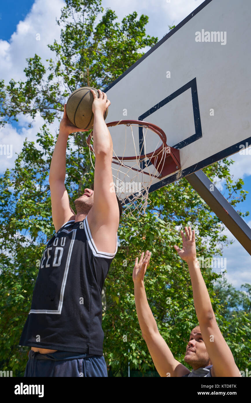 Basketball player in action flying high and scoring Stock Photo - Alamy