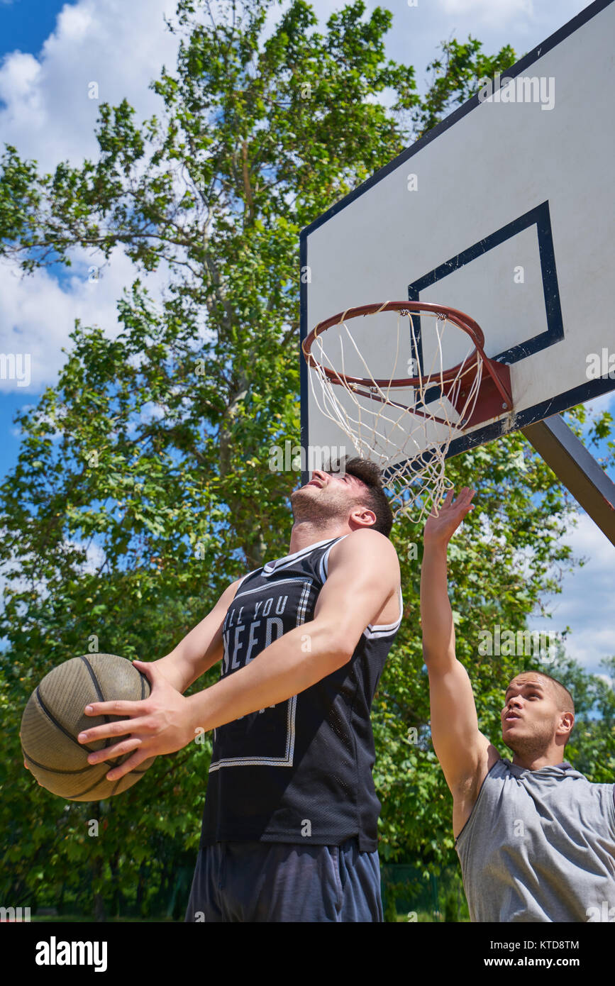 Basketball player in action flying high and scoring Stock Photo - Alamy