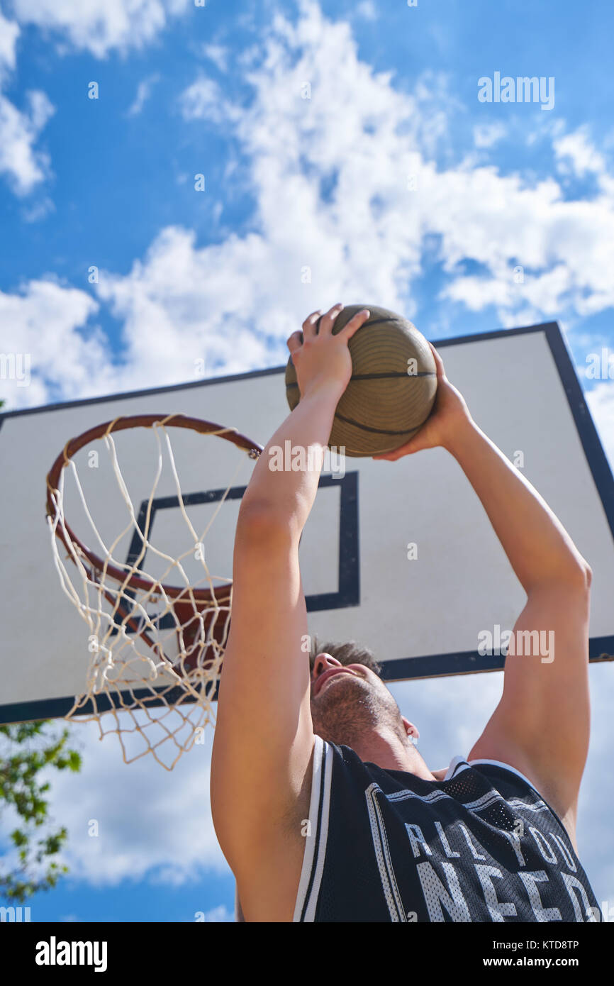 Basketball player in action flying high and scoring Stock Photo - Alamy
