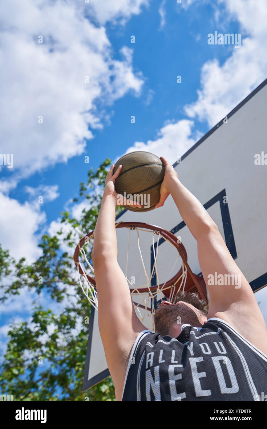 Basketball player in action flying high and scoring Stock Photo - Alamy
