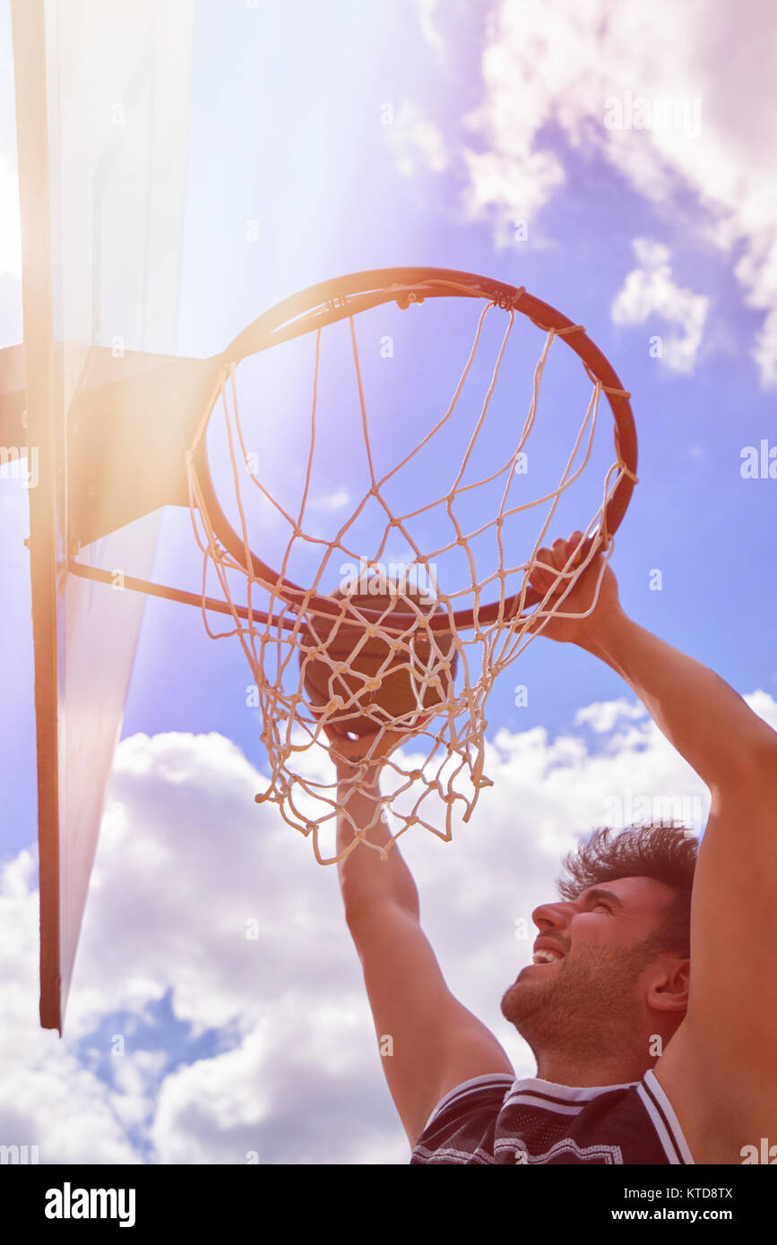 Basketball player in action flying high and scoring Stock Photo - Alamy