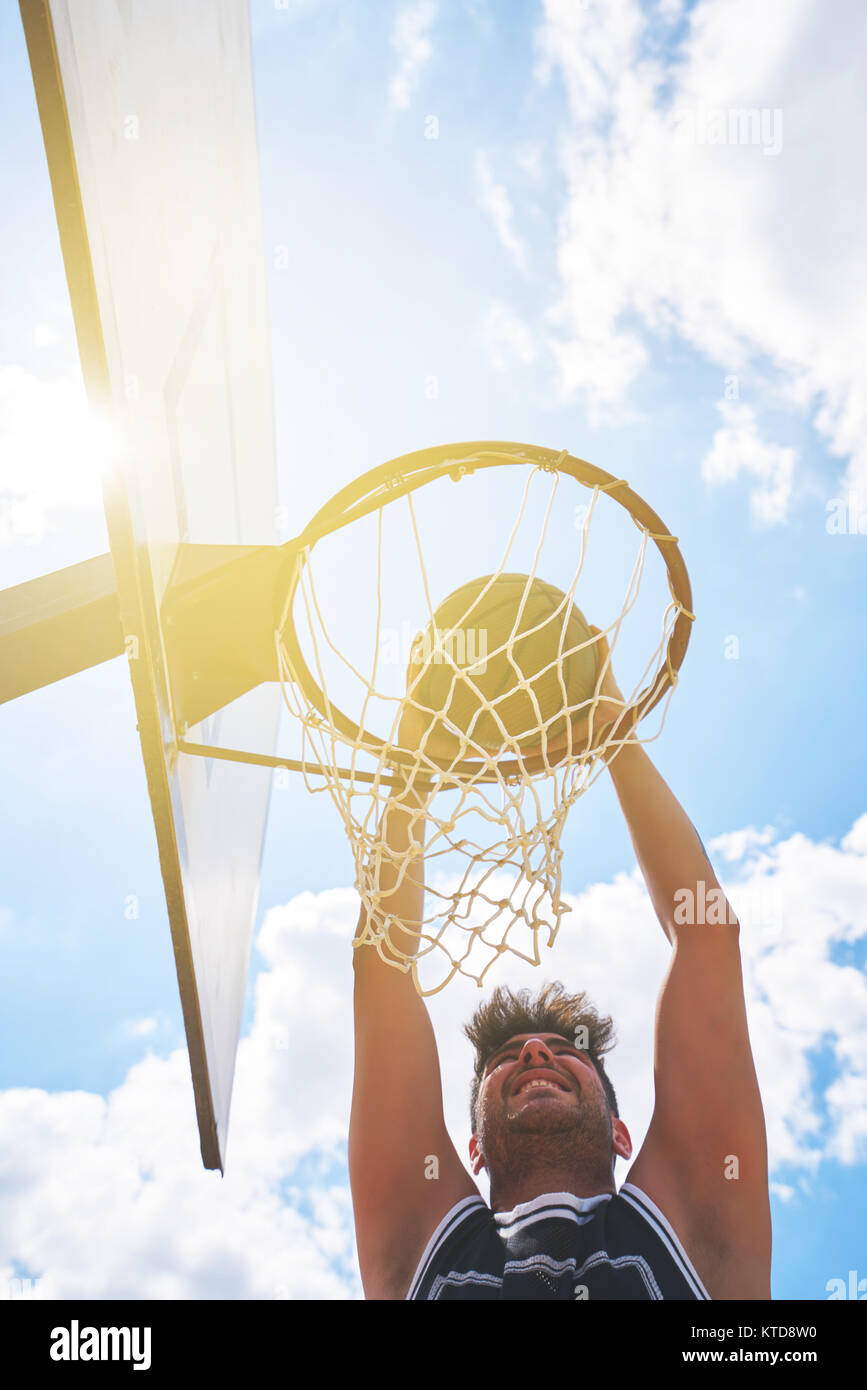 Basketball player in action flying high and scoring Stock Photo - Alamy