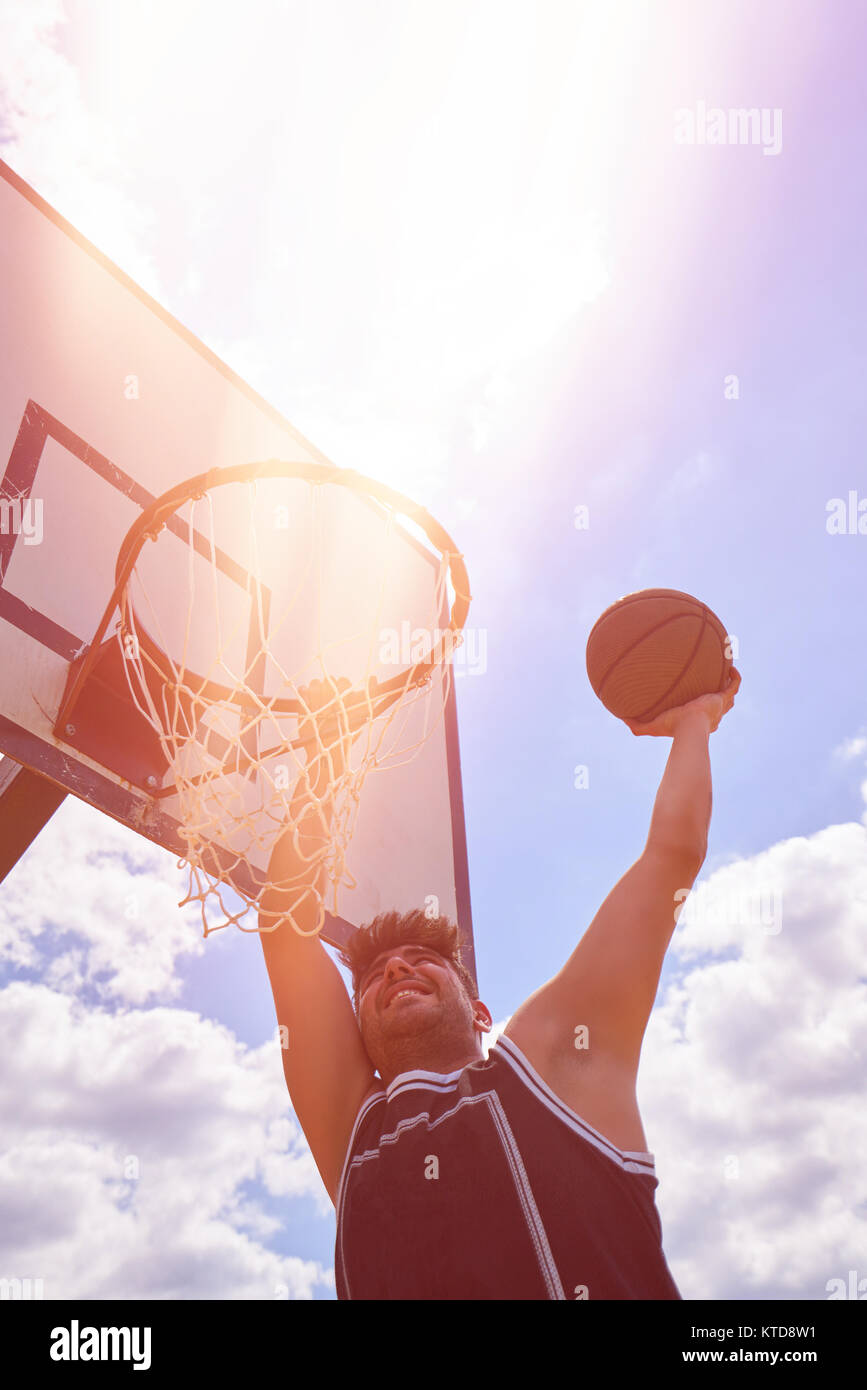 Basketball player in action flying high and scoring Stock Photo - Alamy