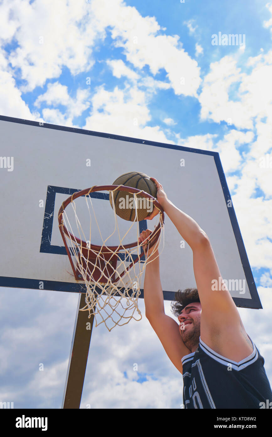 Basketball player in action flying high and scoring Stock Photo - Alamy