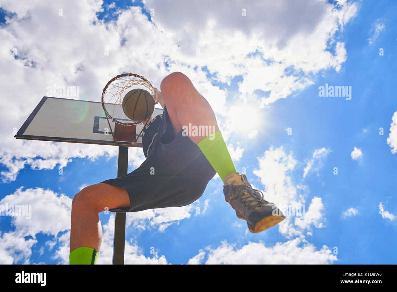 Basketball player in action flying high and scoring Stock Photo - Alamy