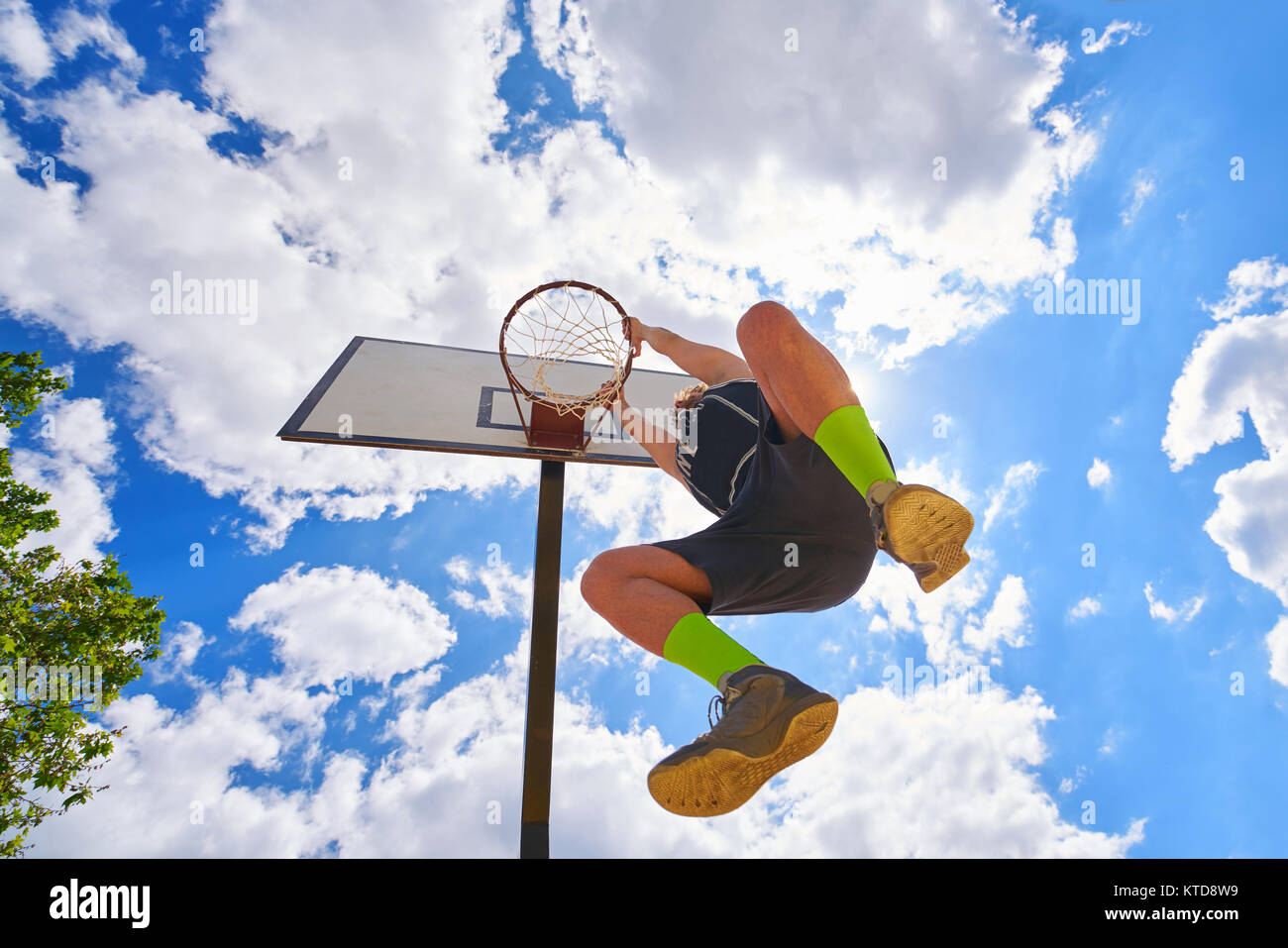 Basketball player in action flying high and scoring Stock Photo - Alamy
