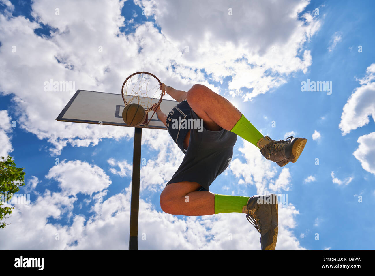 Basketball player in action flying high and scoring Stock Photo - Alamy