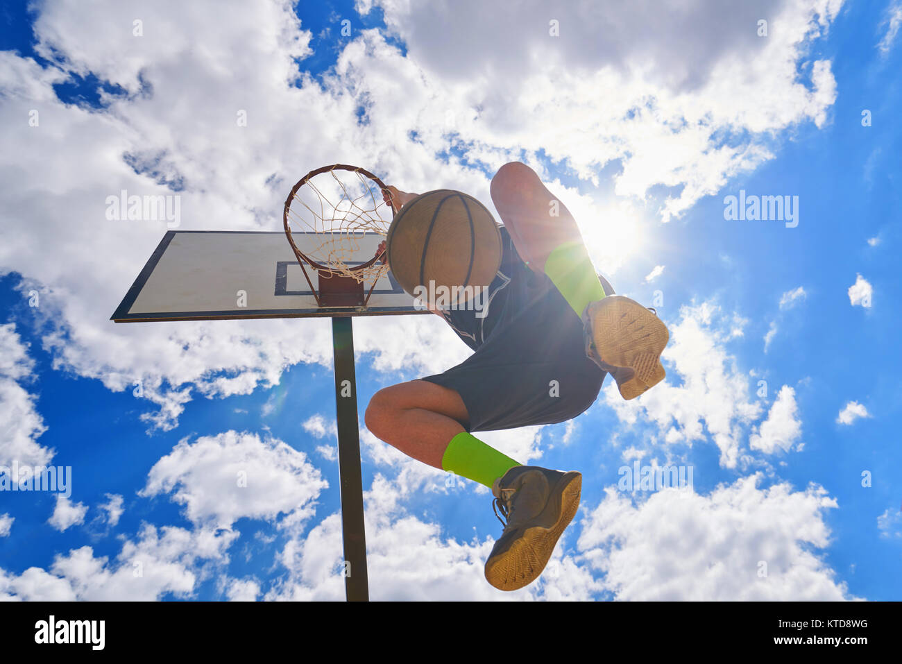 Basketball player in action flying high and scoring Stock Photo - Alamy