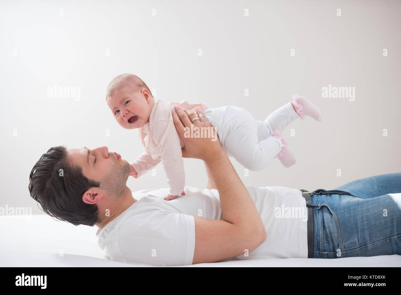 Young father playing with his little baby Stock Photo - Alamy