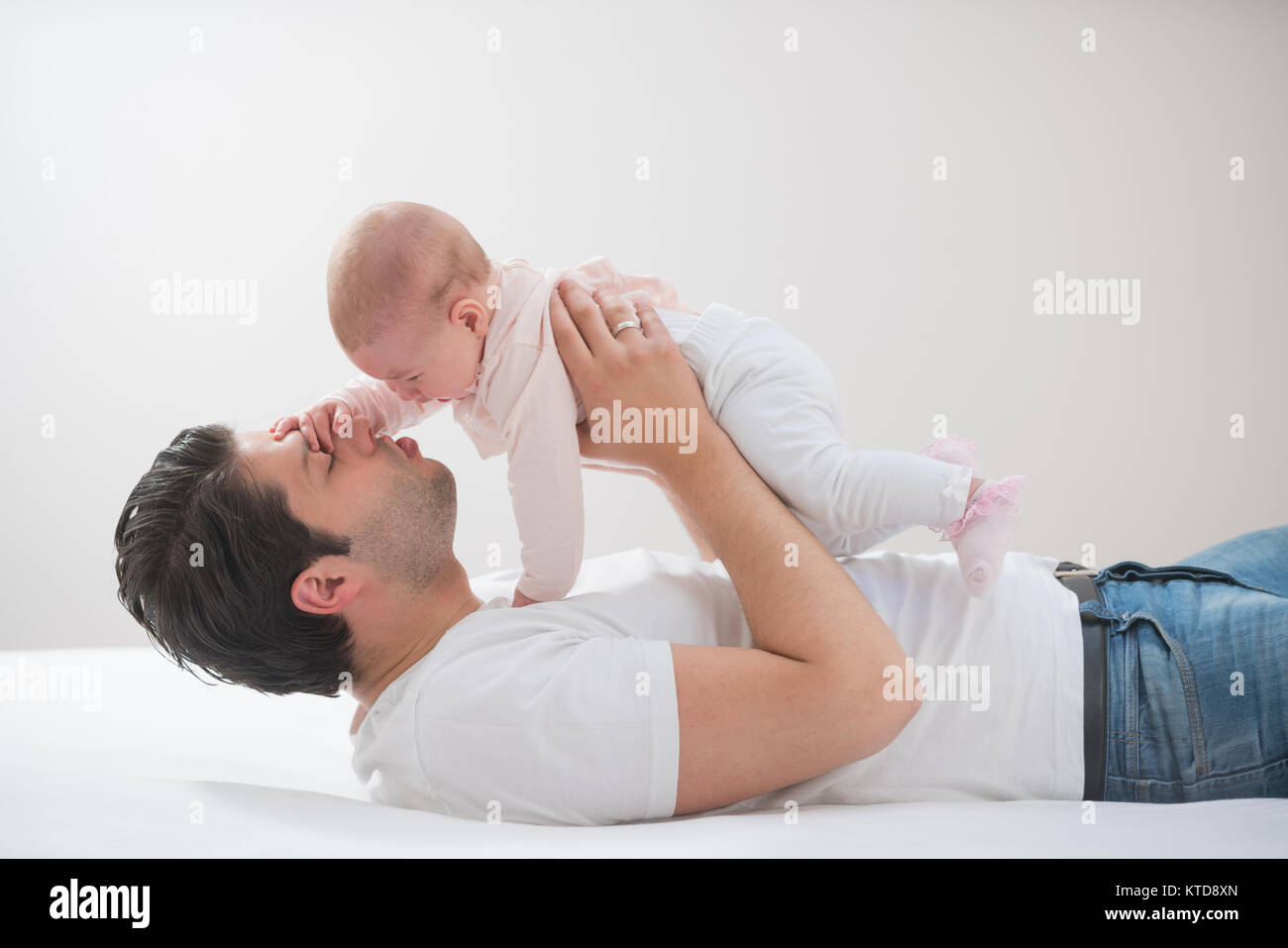 Young father playing with his little baby Stock Photo - Alamy