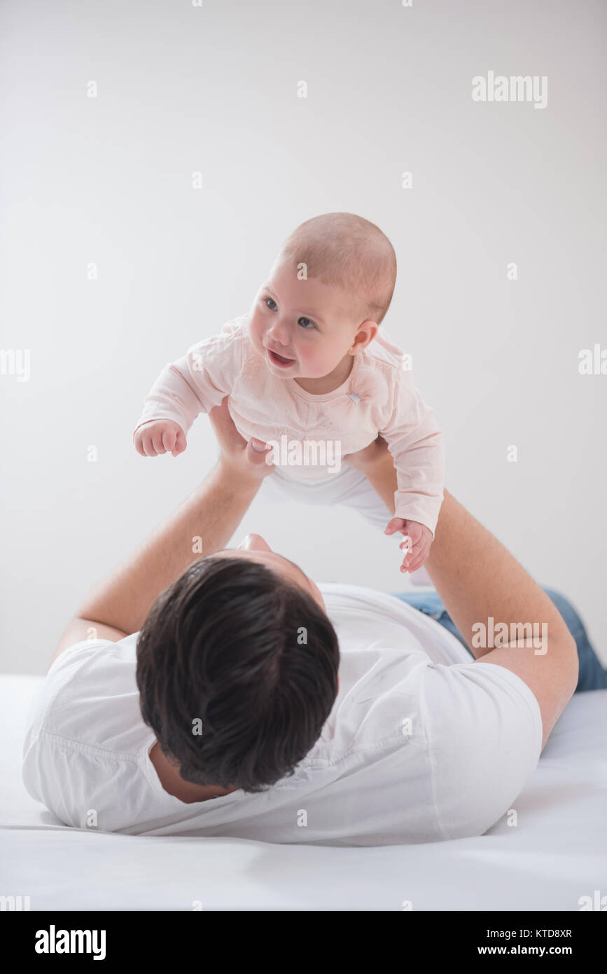 Young father playing with his little baby Stock Photo - Alamy