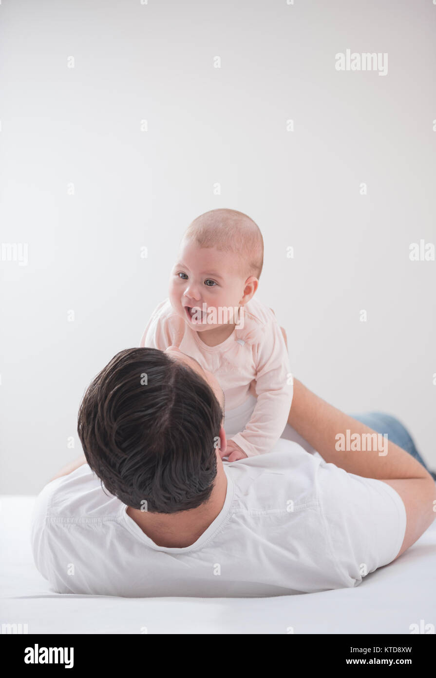 Young father playing with his little baby Stock Photo - Alamy