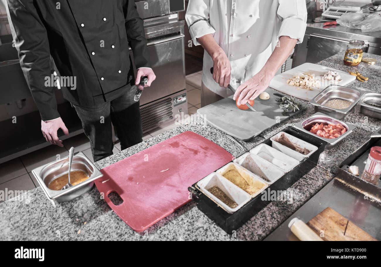 Chef sprinkling spices on dish in commercial kitchen Stock Photo - Alamy