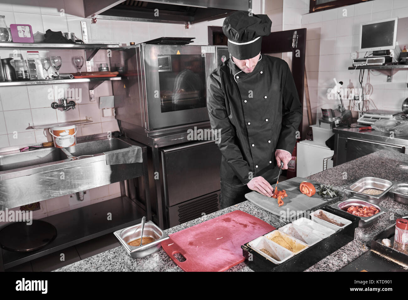 Chef sprinkling spices on dish in commercial kitchen Stock Photo - Alamy