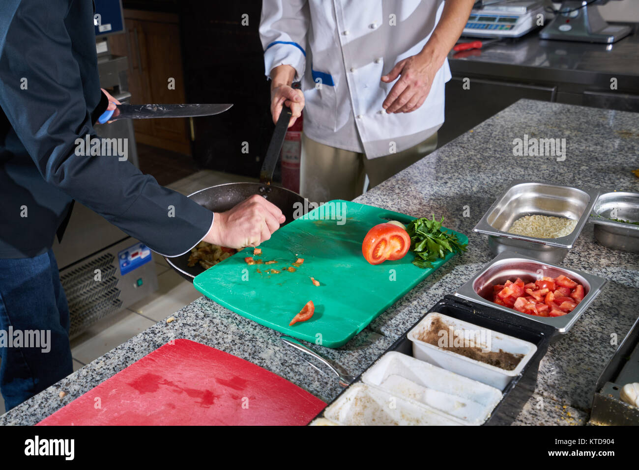 Chef sprinkling spices on dish in commercial kitchen Stock Photo - Alamy