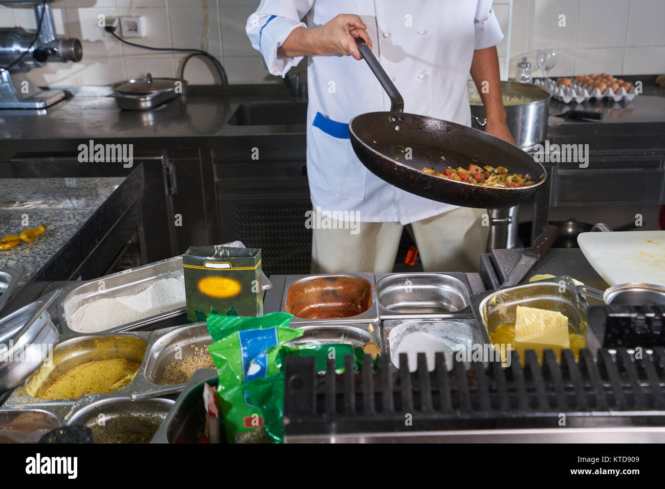 Chef sprinkling spices on dish in commercial kitchen Stock Photo - Alamy