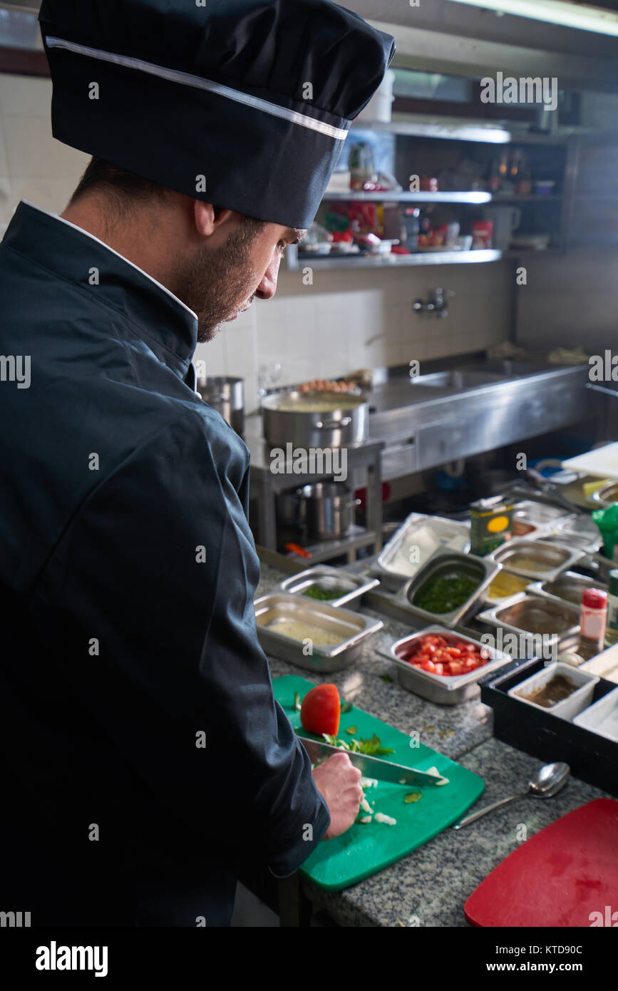 Chef sprinkling spices on dish in commercial kitchen Stock Photo - Alamy