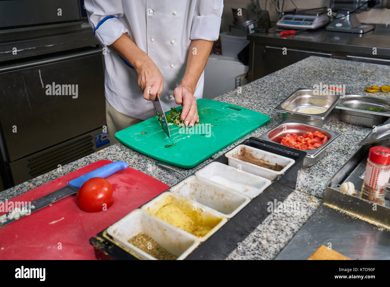 Chef sprinkling spices on dish in commercial kitchen Stock Photo - Alamy