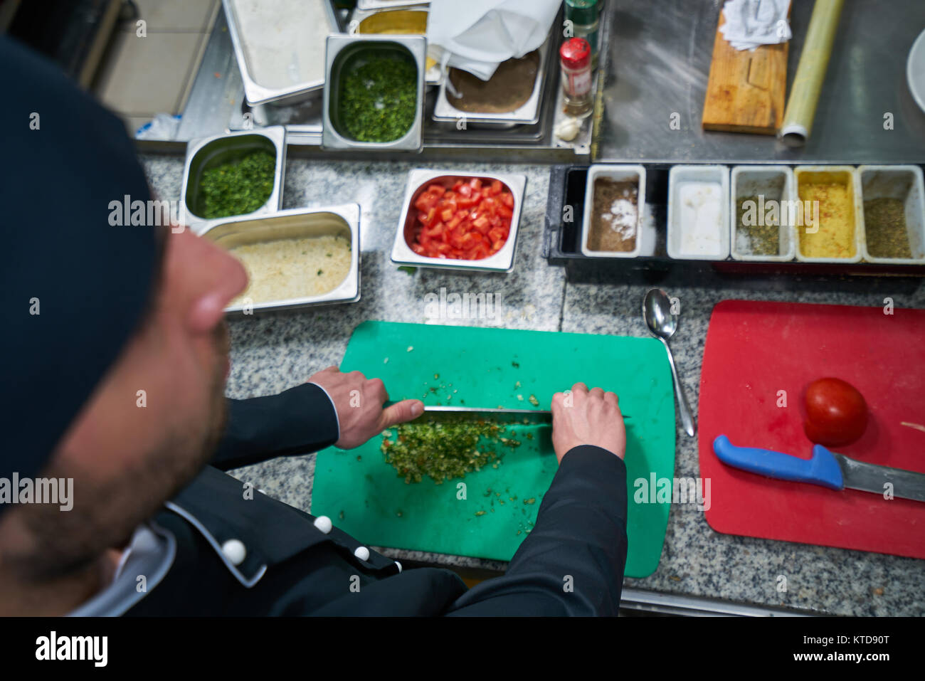 Chef sprinkling spices on dish in commercial kitchen Stock Photo - Alamy