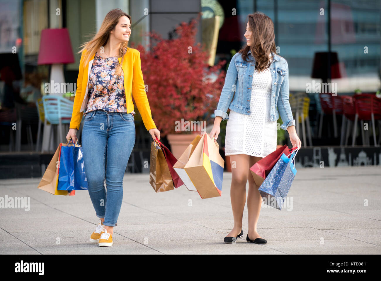 Happy girls shopping in late autumn. bags, walking, holidays Stock ...