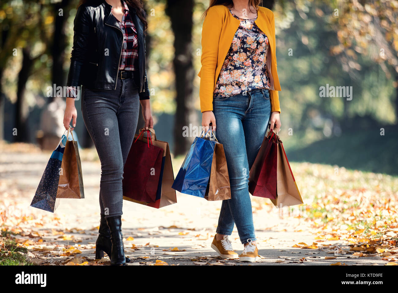 Happy girls shopping in late autumn. bags, walking, holidays Stock ...