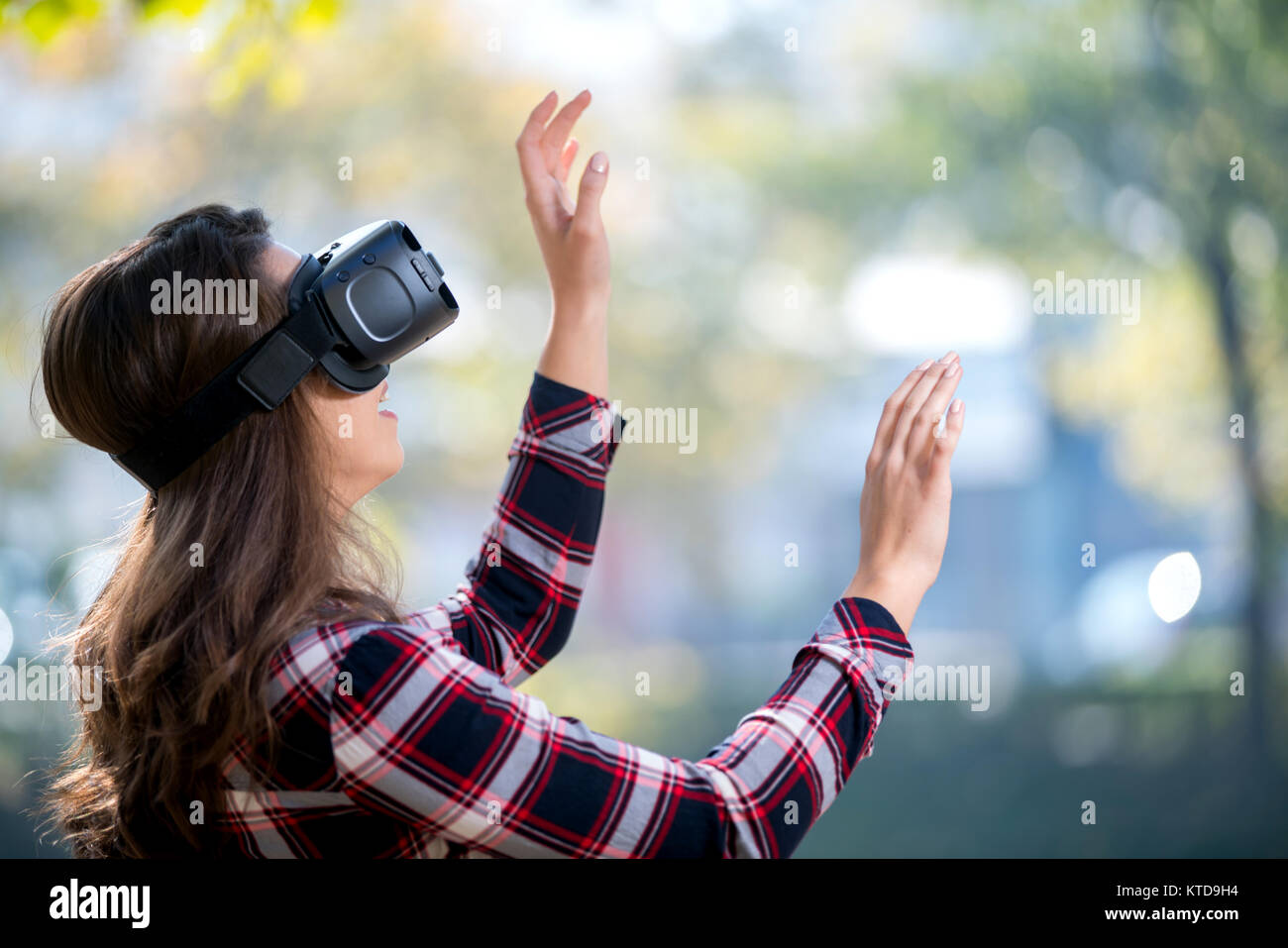 Pretty girl using VR headset outside in the park having fun Stock Photo ...